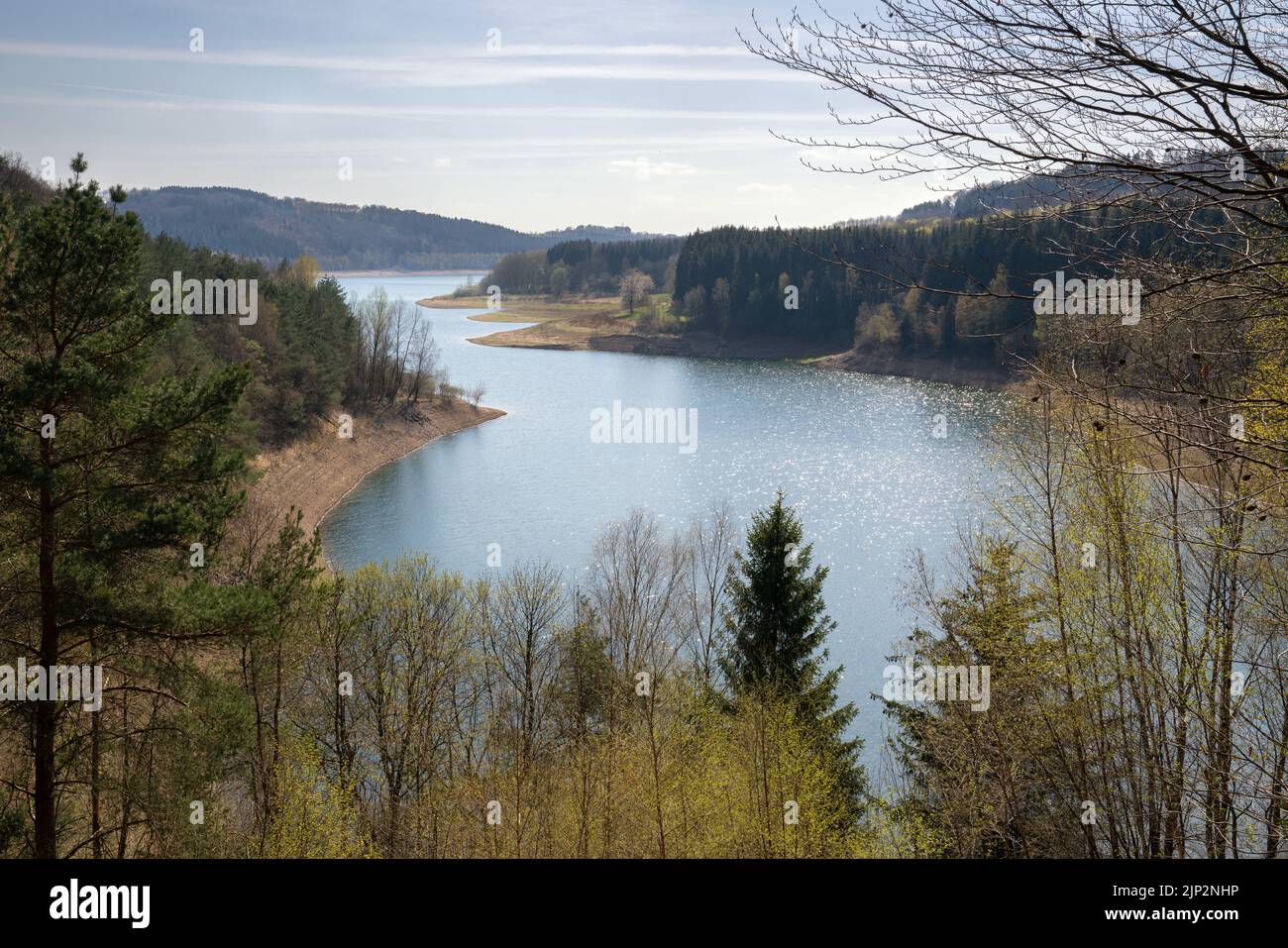 An aerial shot of Dhunntalsperre lake surrounded by green hills in ...