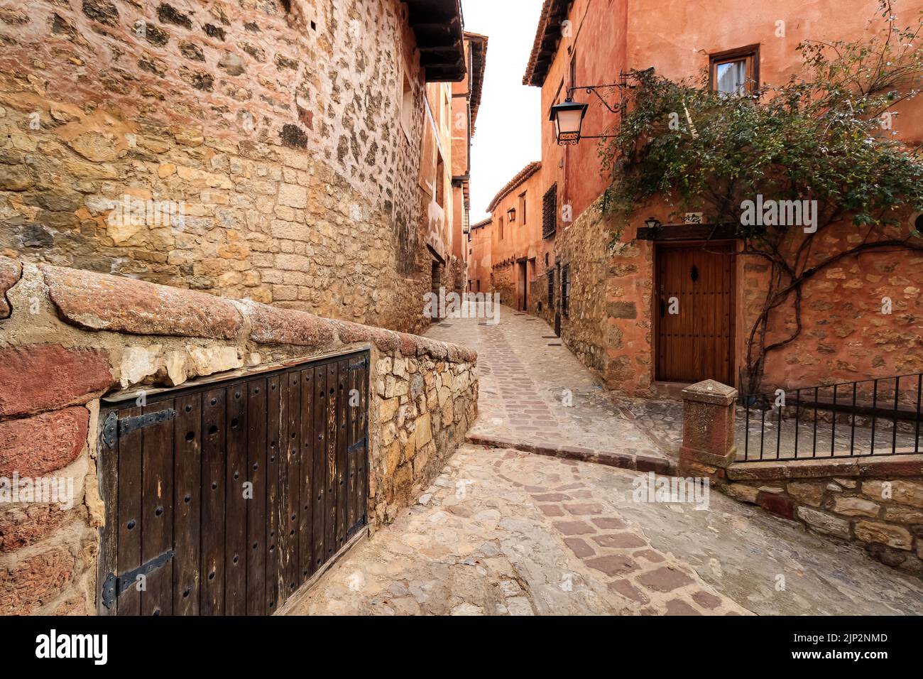 Narrow alley with old stone houses in medieval style in the town of ...