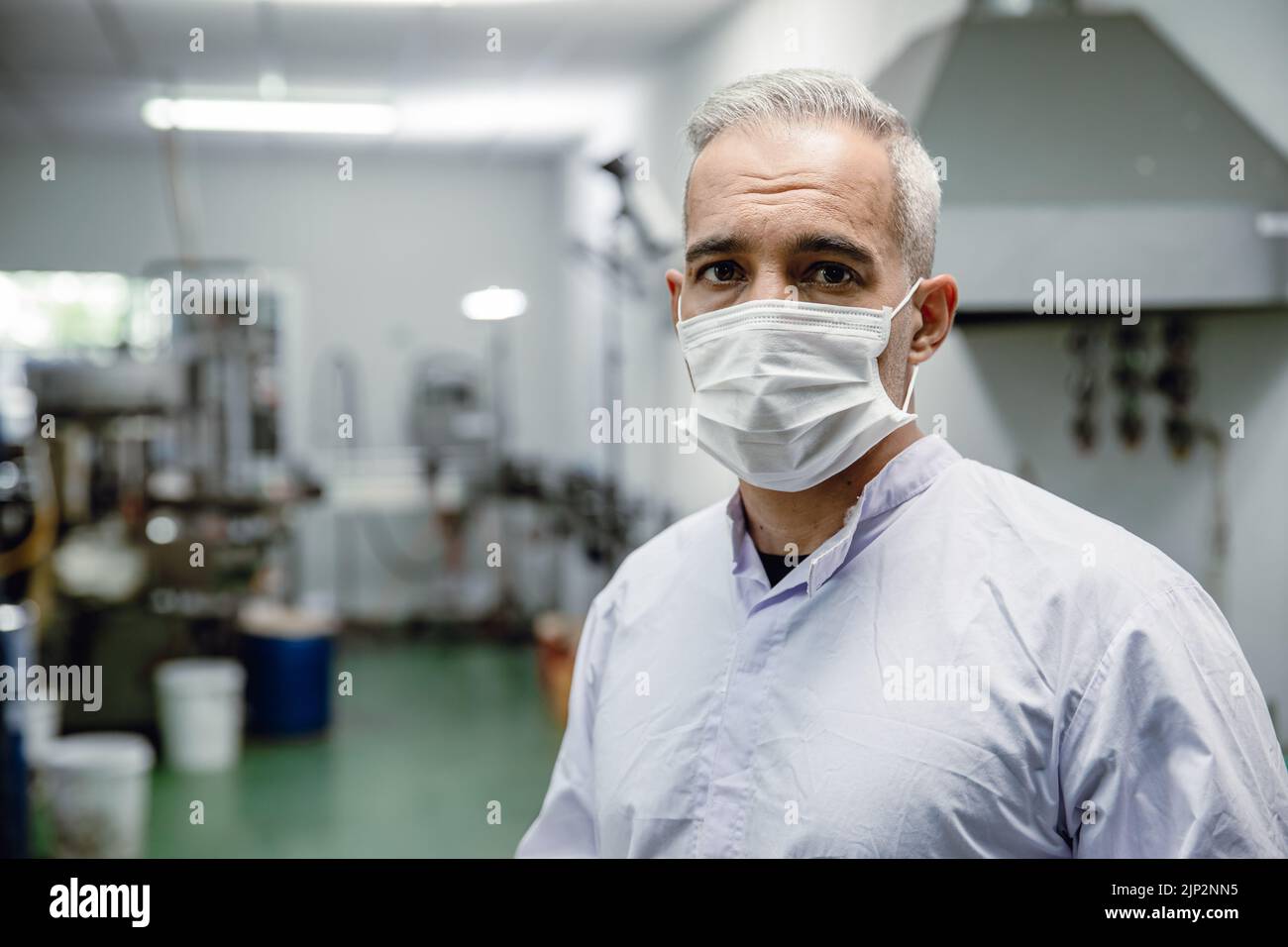 Italian European worker working in food factory portrait waring face ...