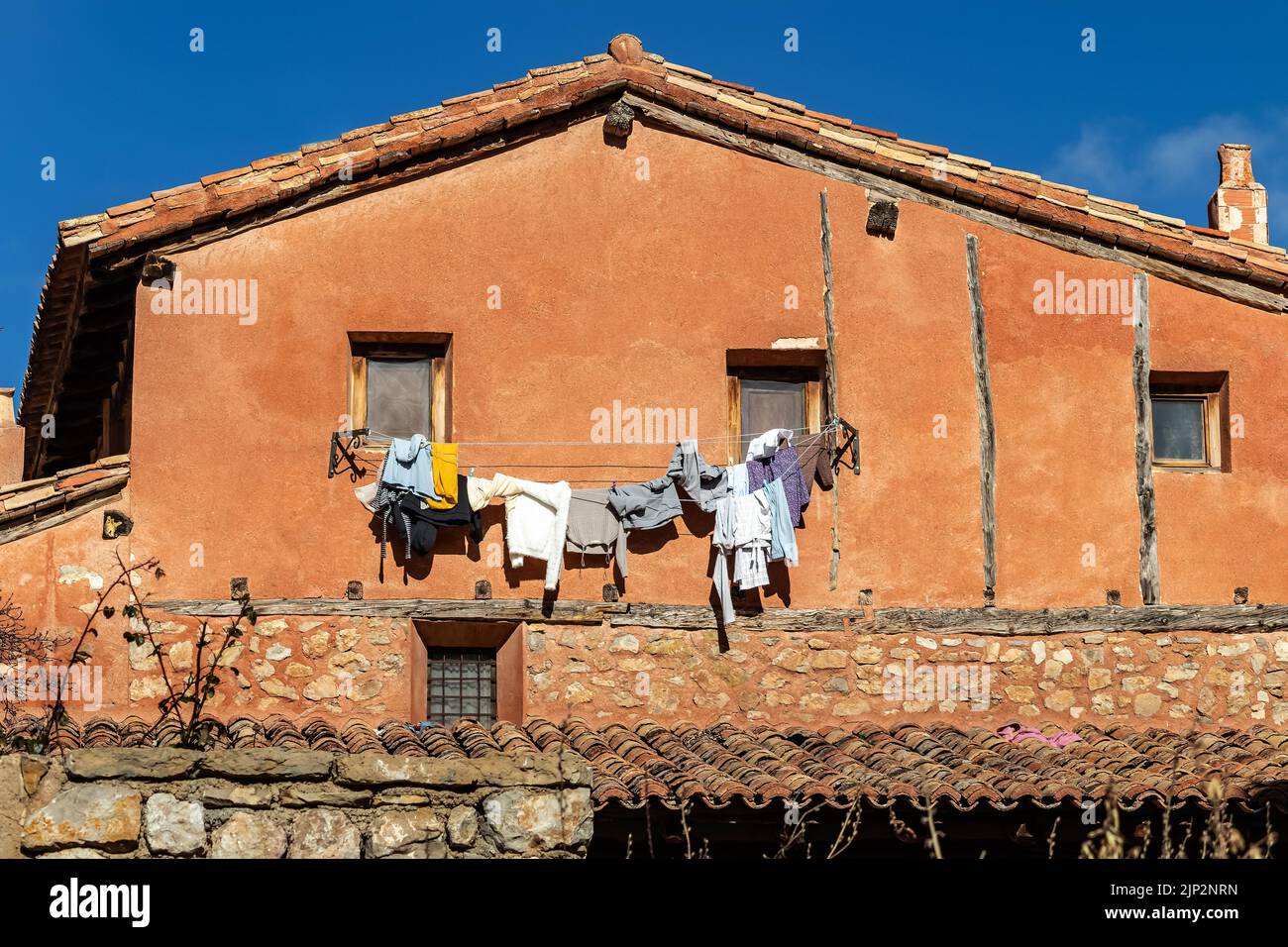 Old house with washed clothes hanging on ropes hanging from the windows ...