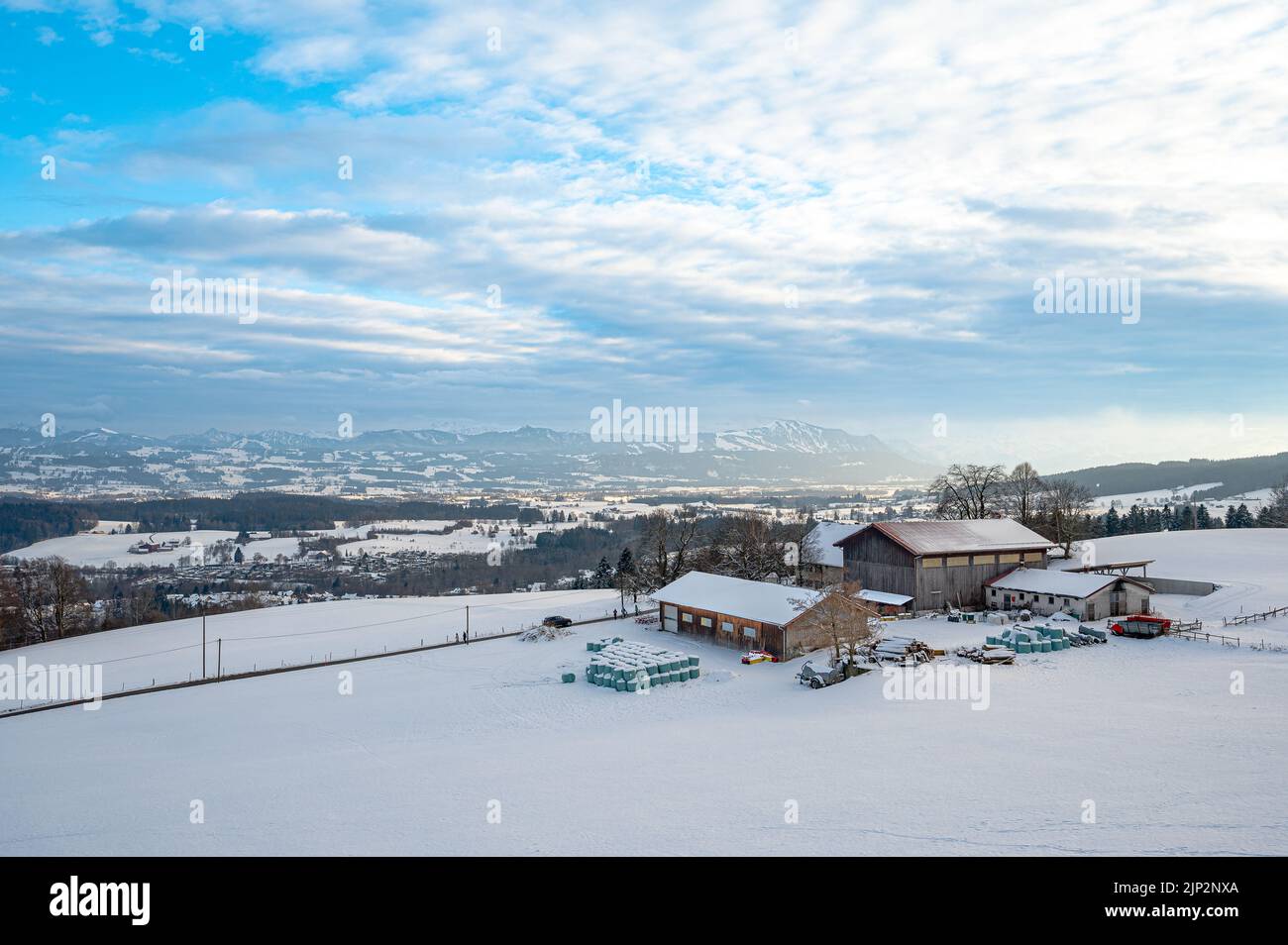 A winter landscape with a snowy farm with houses in Kempten, Bavaria ...
