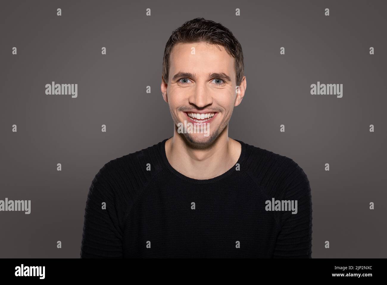 Closeup of a humorous happy man laughing intro camera with open mouth ...