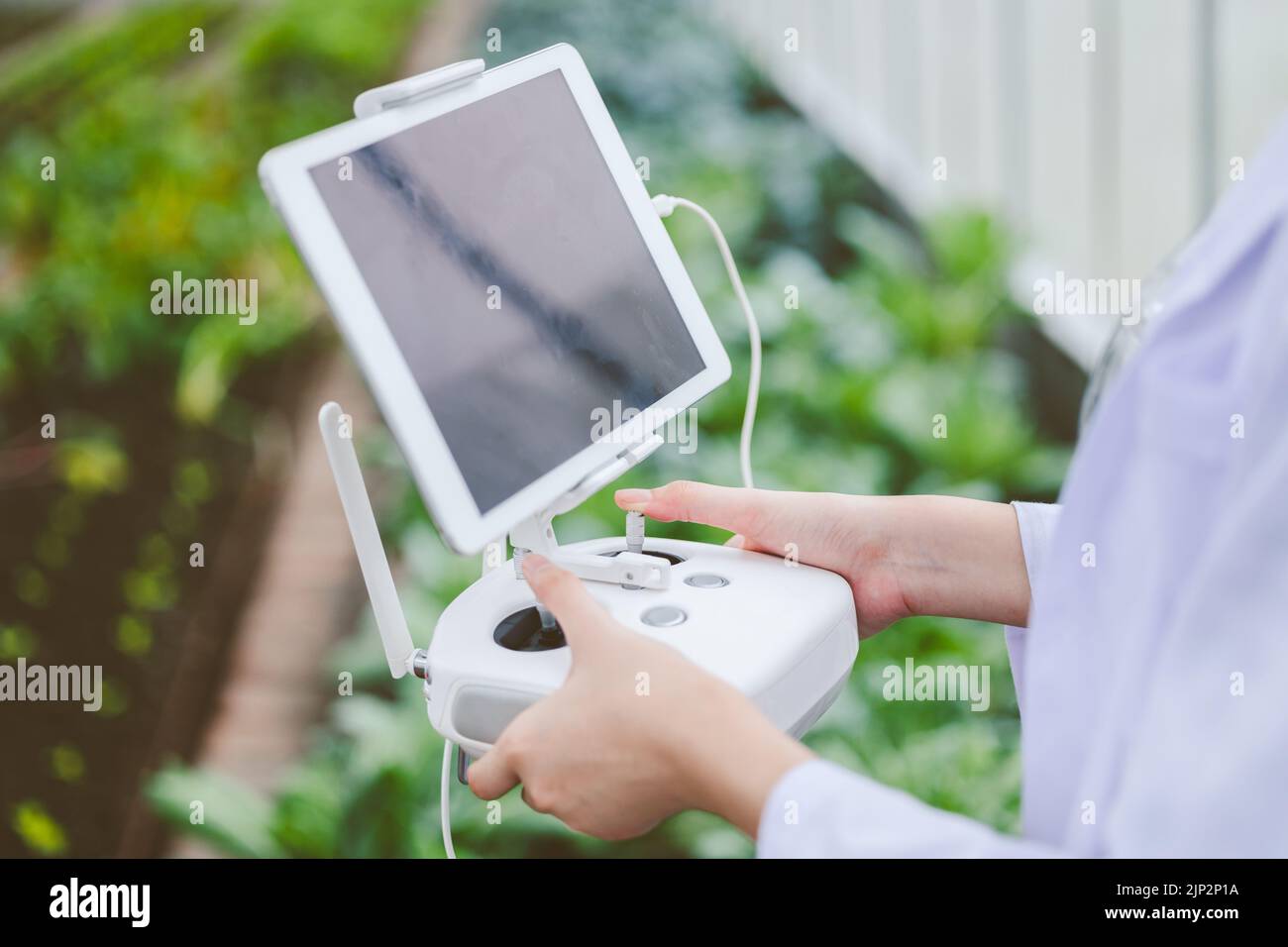 people hand holding drone controller with black large screen monitor in ...