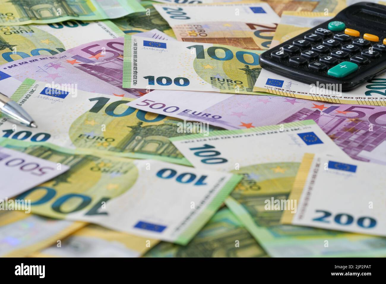 A heap of Euro banknotes on a table - business and investment concept ...