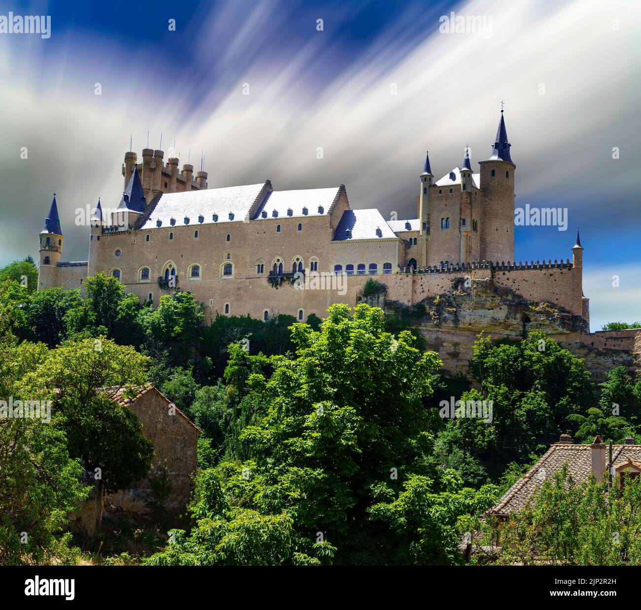 Medieval Castle on top of the mountain with green vegetation and blue ...
