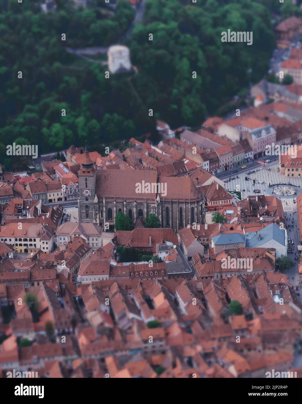 A vertical shot of a city full of different buildings and roads from a ...