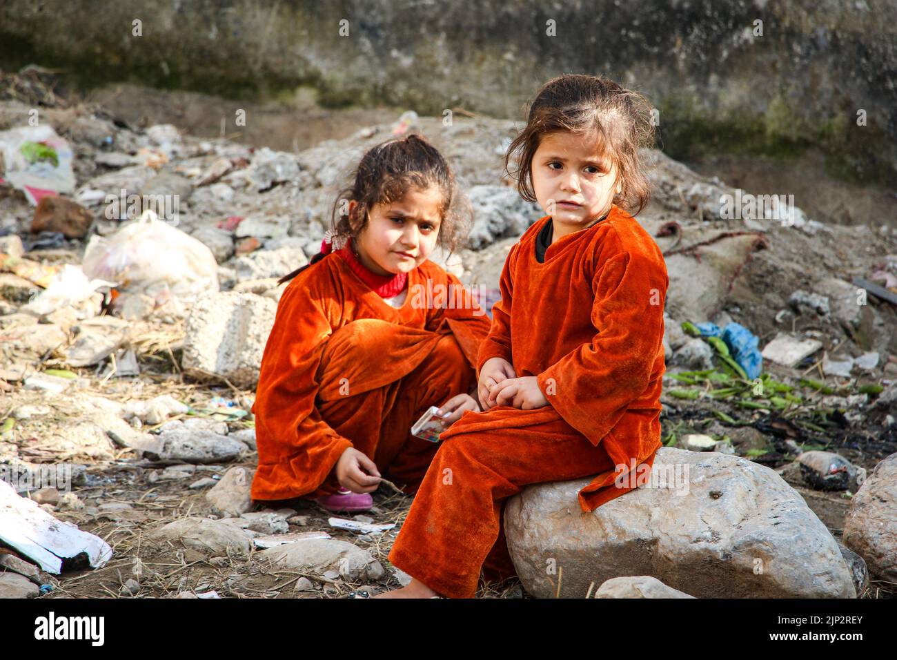 Homeless Children suffering from hunger and sitting around garbage ...