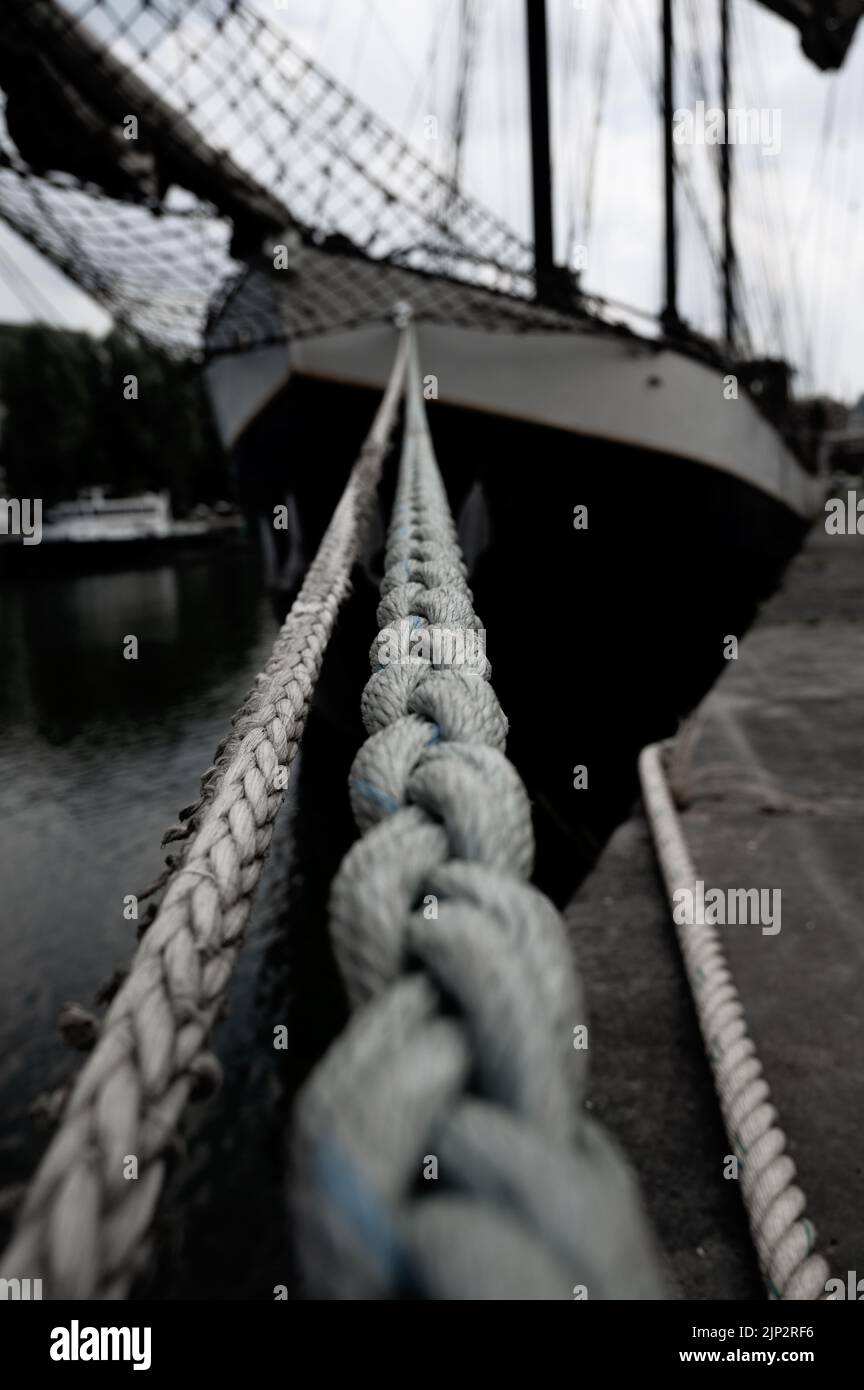 A thick rope holding a ship on the coast, grayscale vertical shot Stock ...