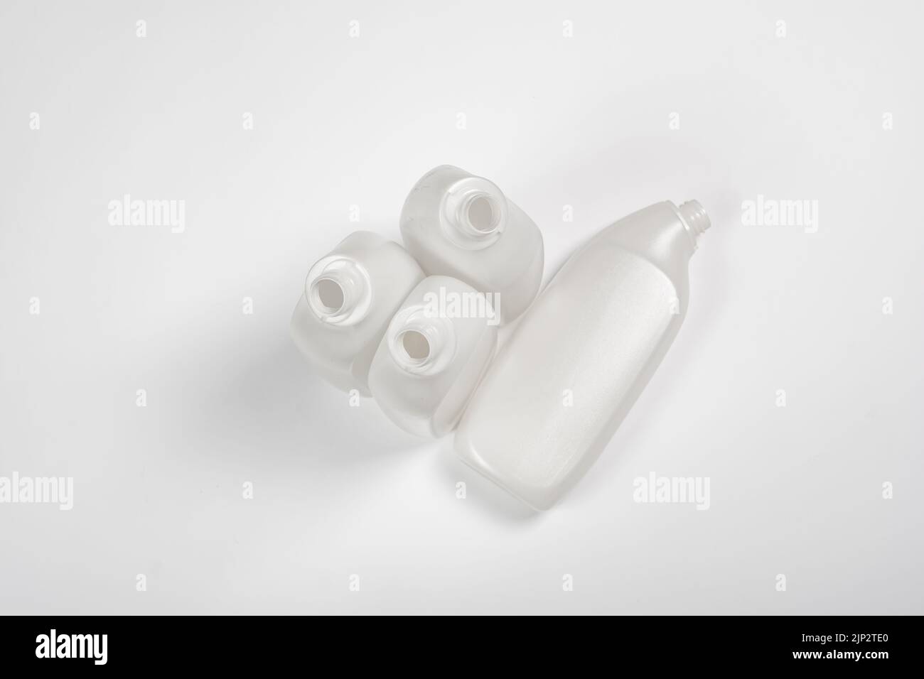 A top view of plastic containers on white background with a gray shade ...