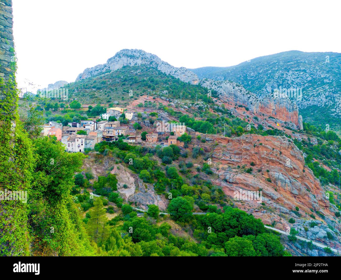 Landscape with a village in a mountain, lake and sky. Pyrenees in ...
