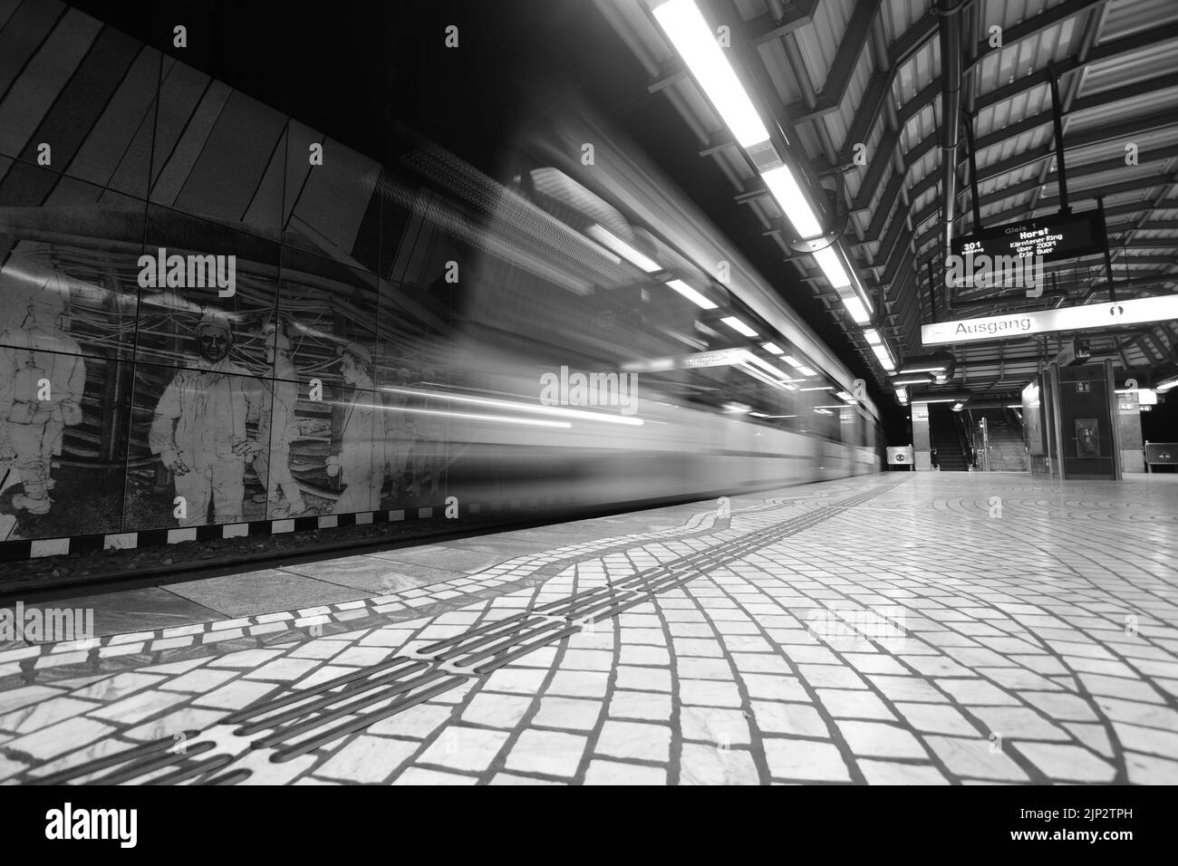 A greyscale long shutter speed shot of an empty metro station in ...