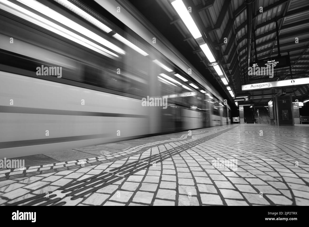 A greyscale long shutter speed shot of an empty train station in ...