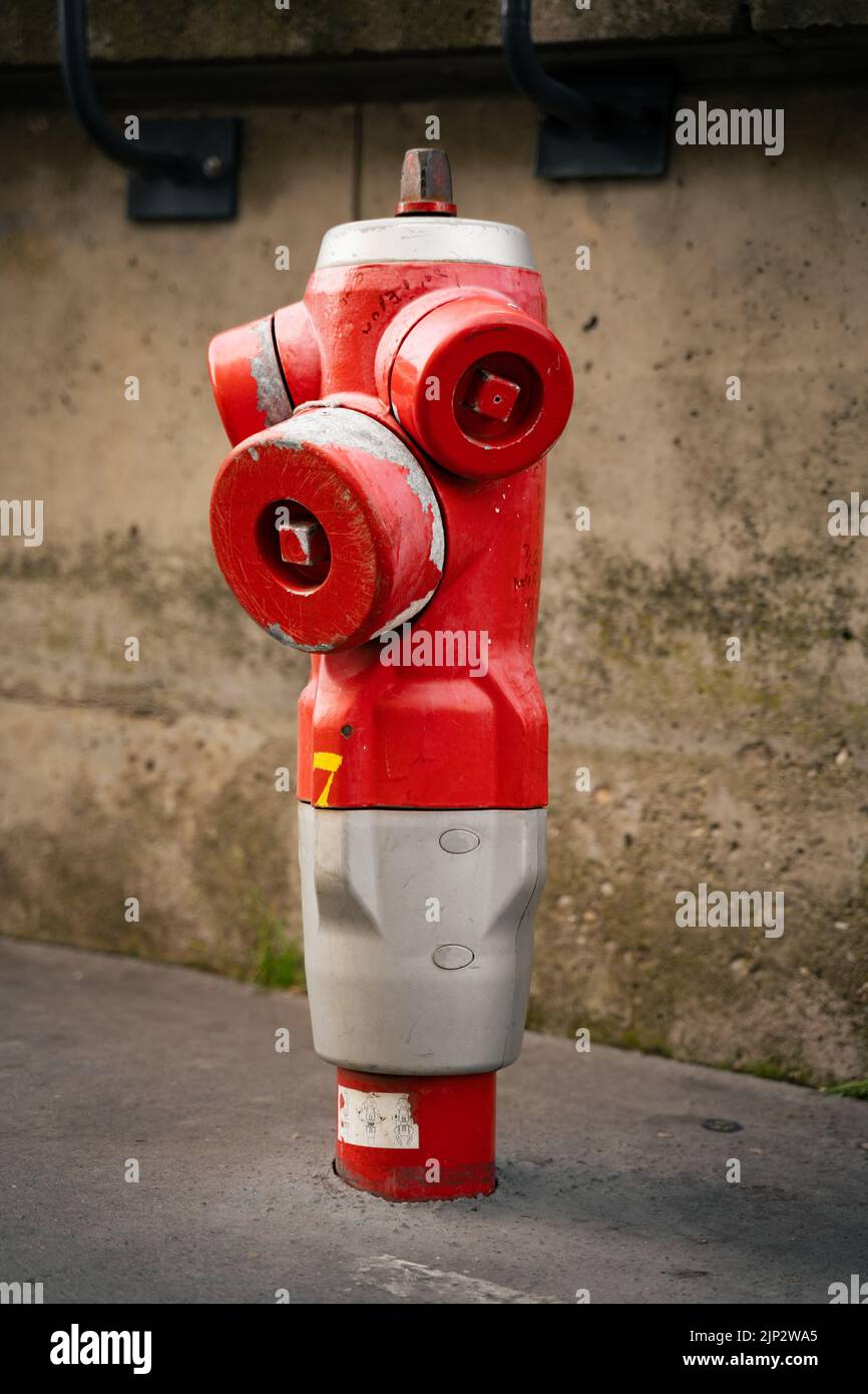 A closeup of a fire hydrant attached to the ground, a vertical view ...