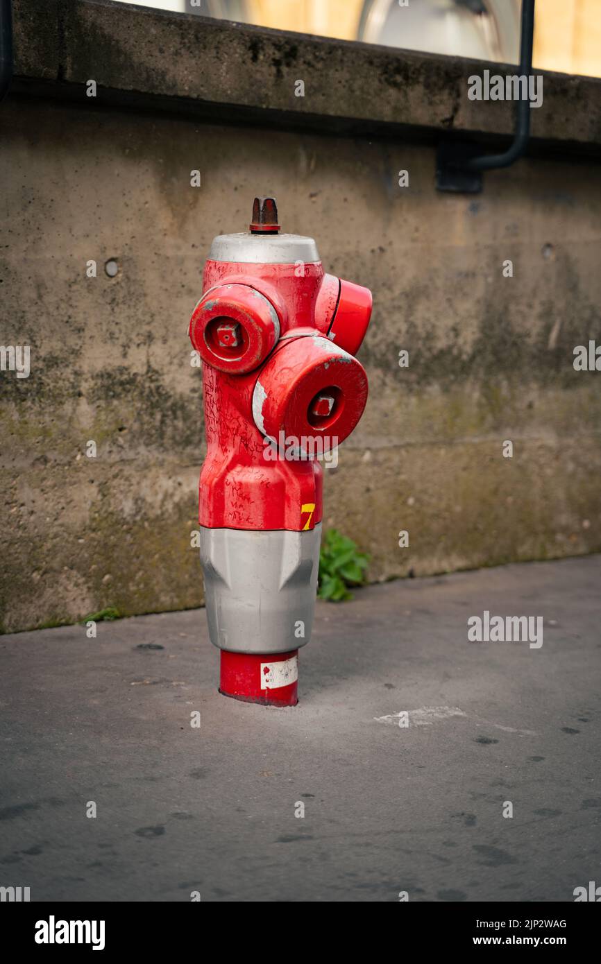 A closeup of a fire hydrant placed on the ground, a vertical view Stock ...