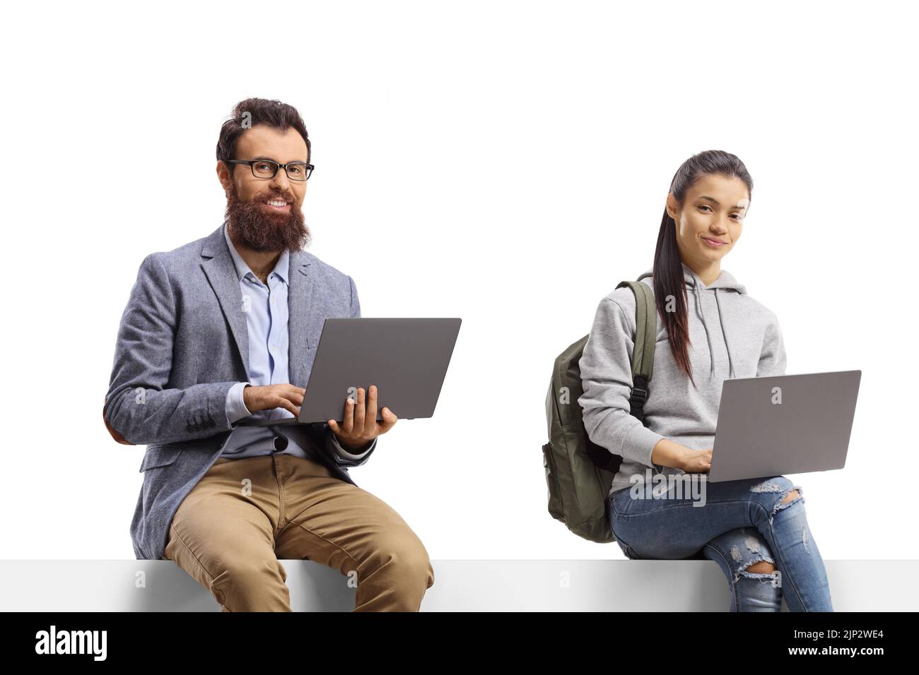 Female student and a bearded man sitting on a blank board with laptop ...