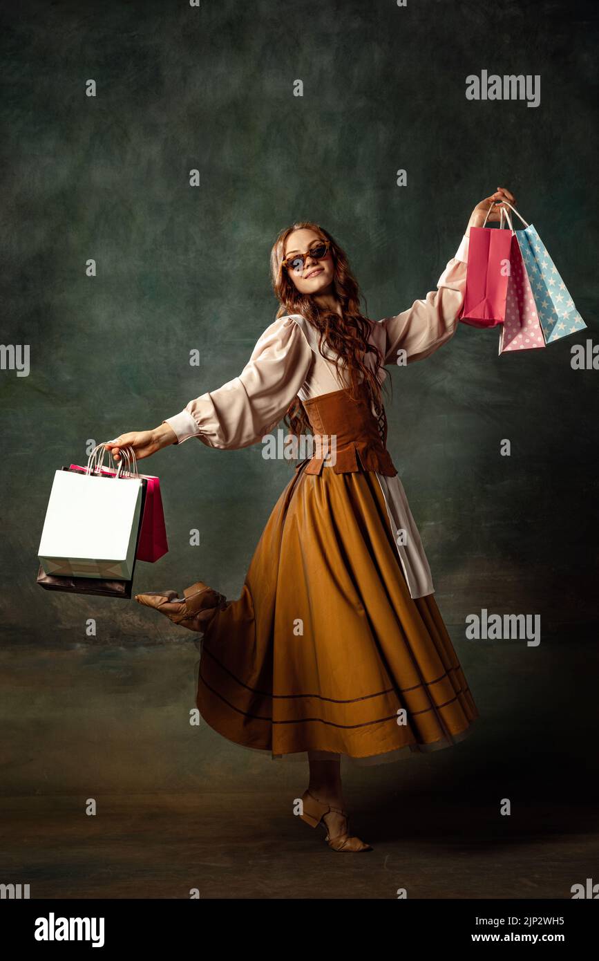 Vintage style portrait of pretty redhead woman with long curly hair ...
