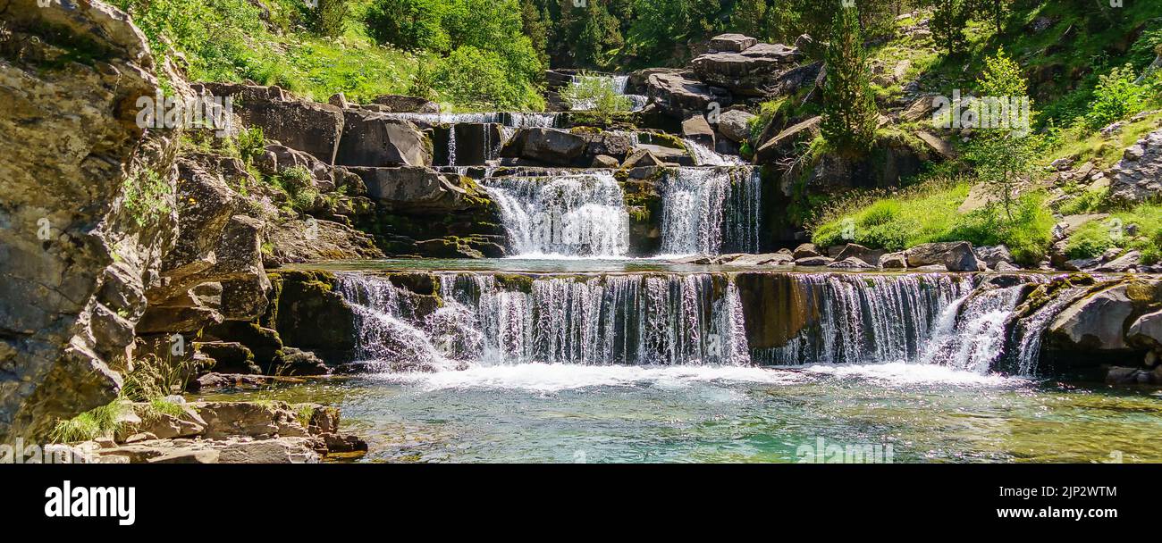 Panoramic waterfall in stands or terraces in green landscape between ...