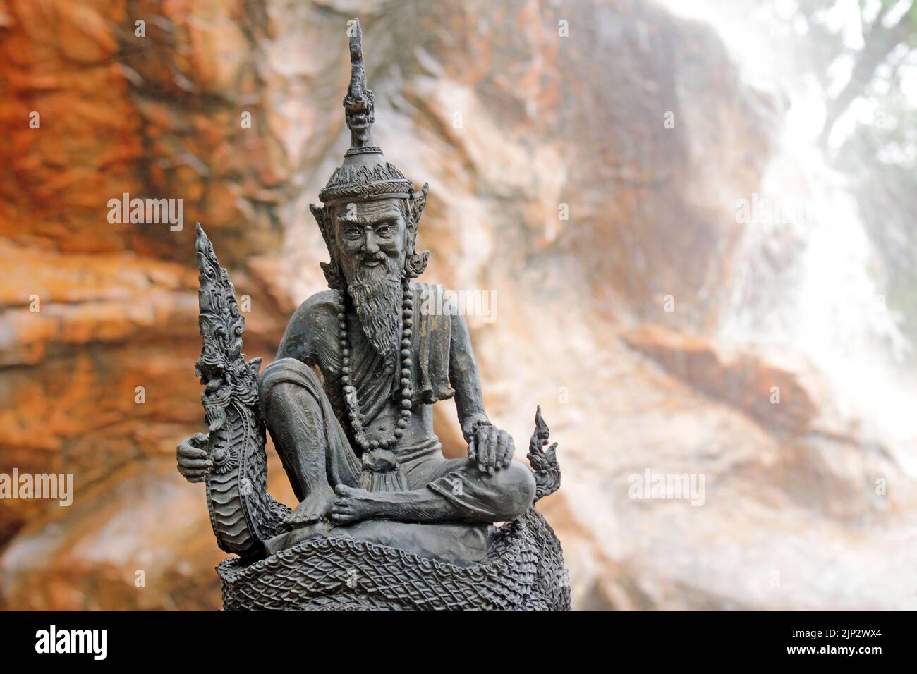 Ancient Buddhist sculpture at a shrine of a male bearded Buddha ...