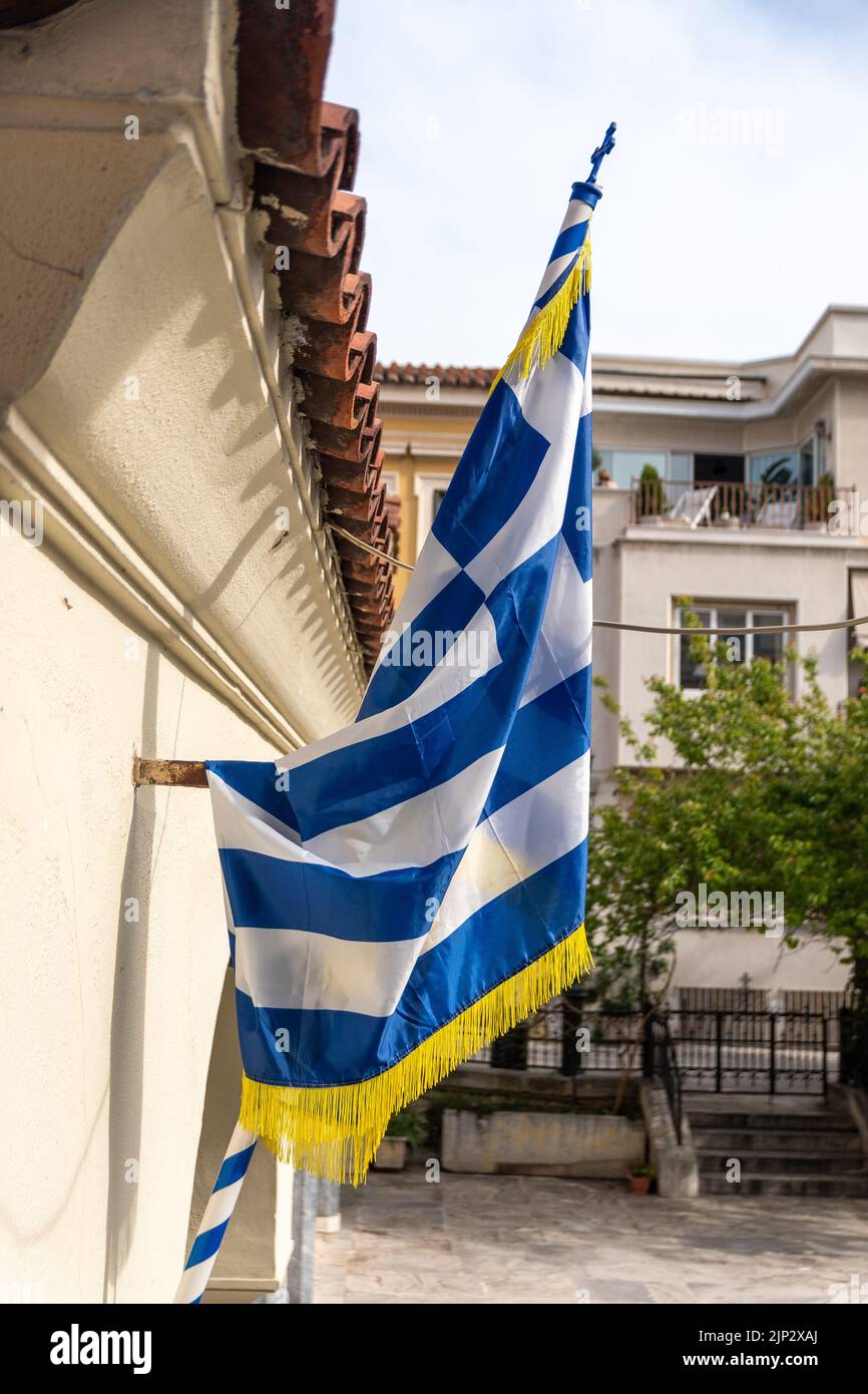 A vertical close-up of a Greek flag hanging on the wall in Athens ...