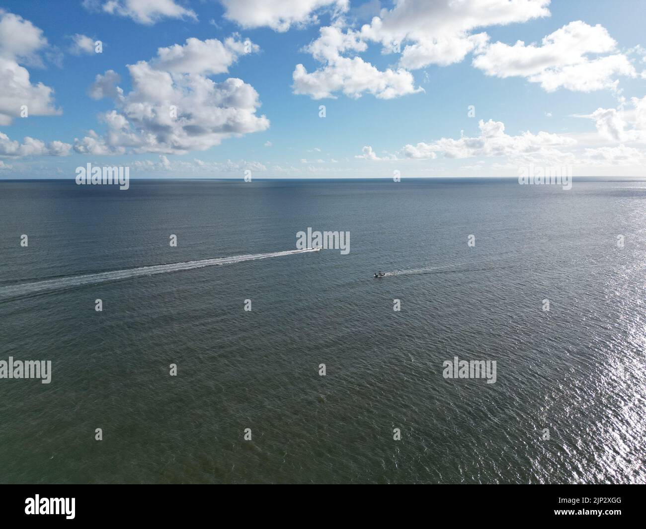 Two boats passing by each other on the water Stock Photo - Alamy