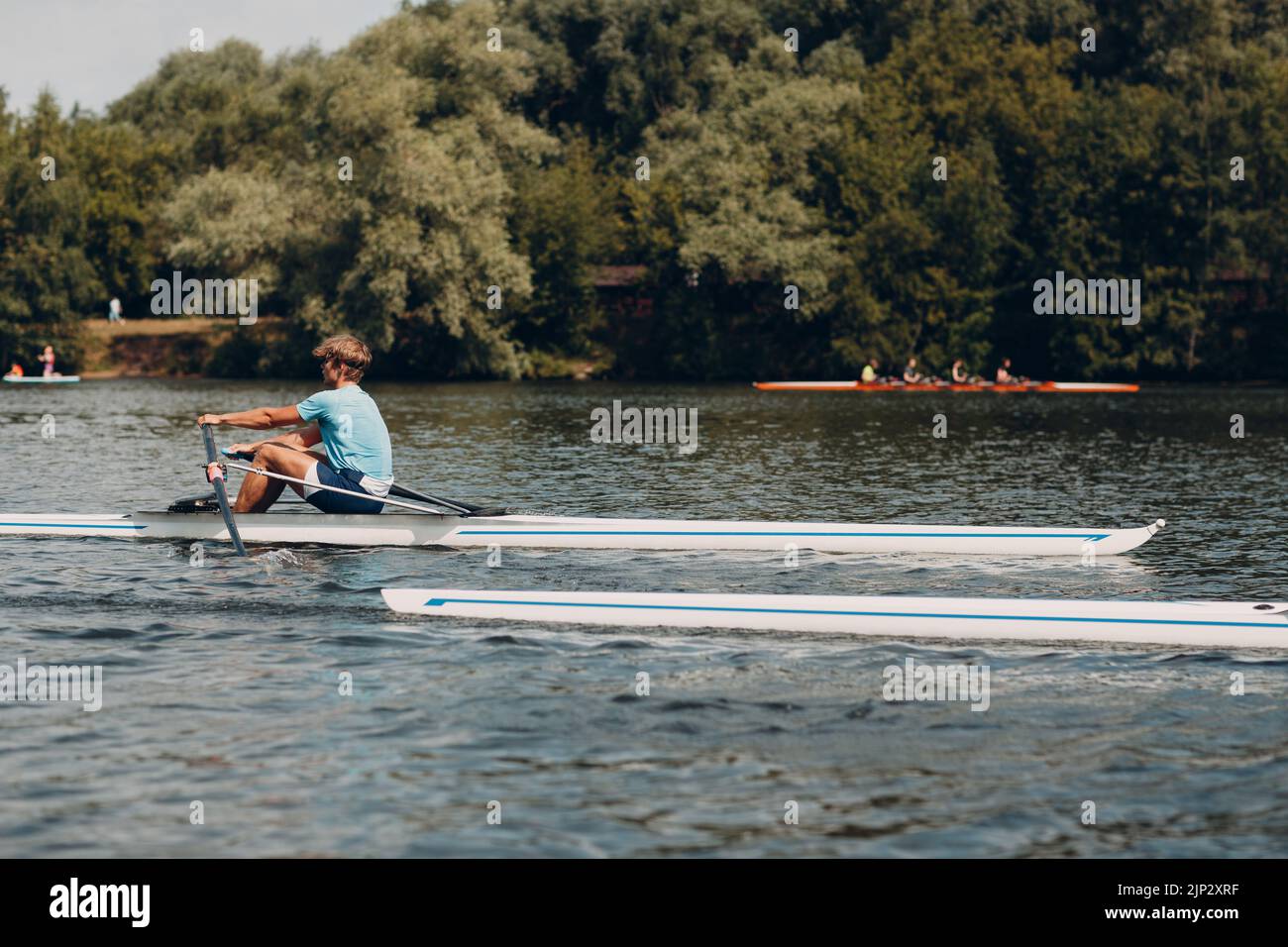 Sportsman single scull man rower rowing on boat Stock Photo - Alamy
