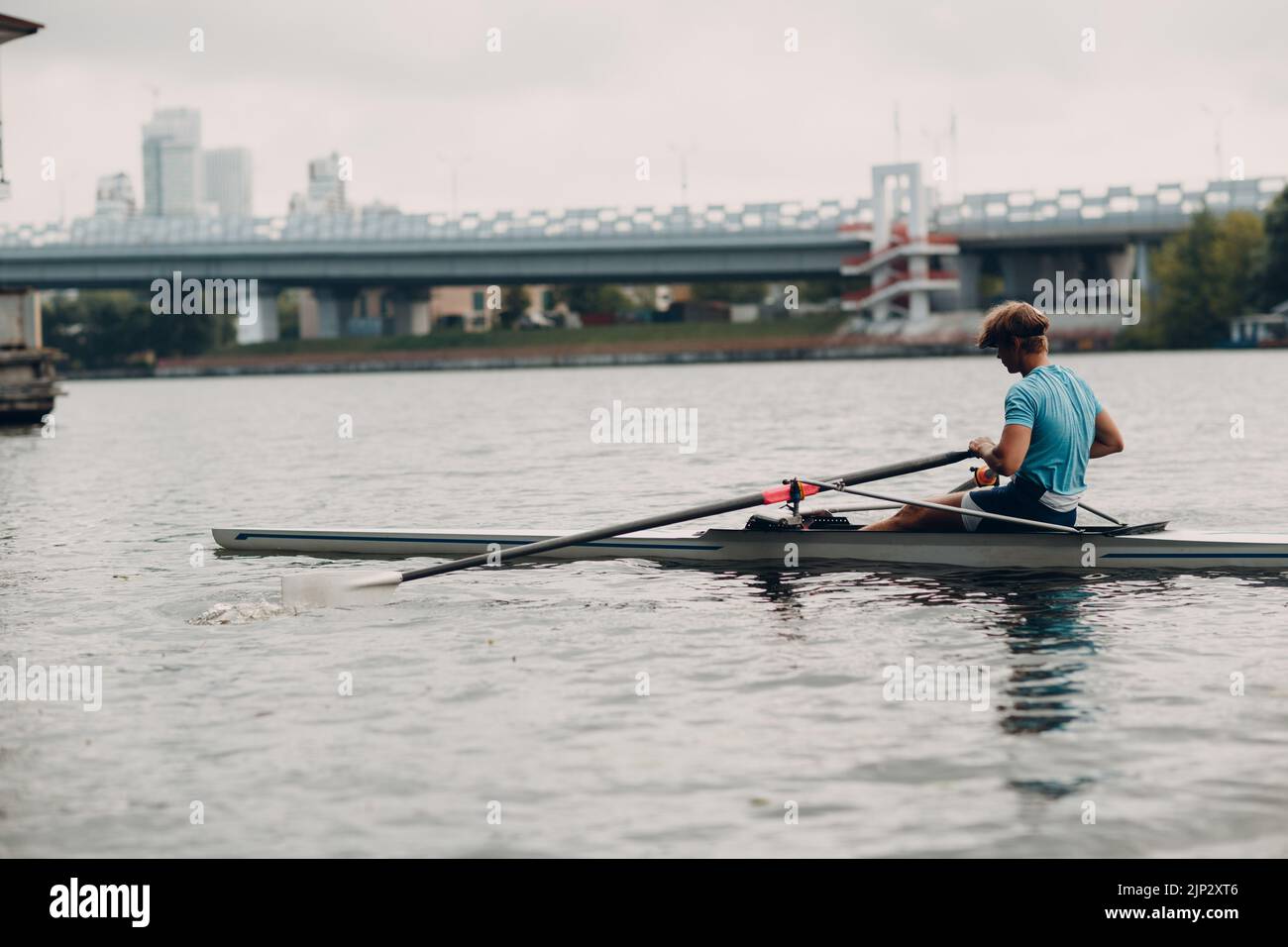 Sportsman single scull man rower rowing on boat Stock Photo - Alamy