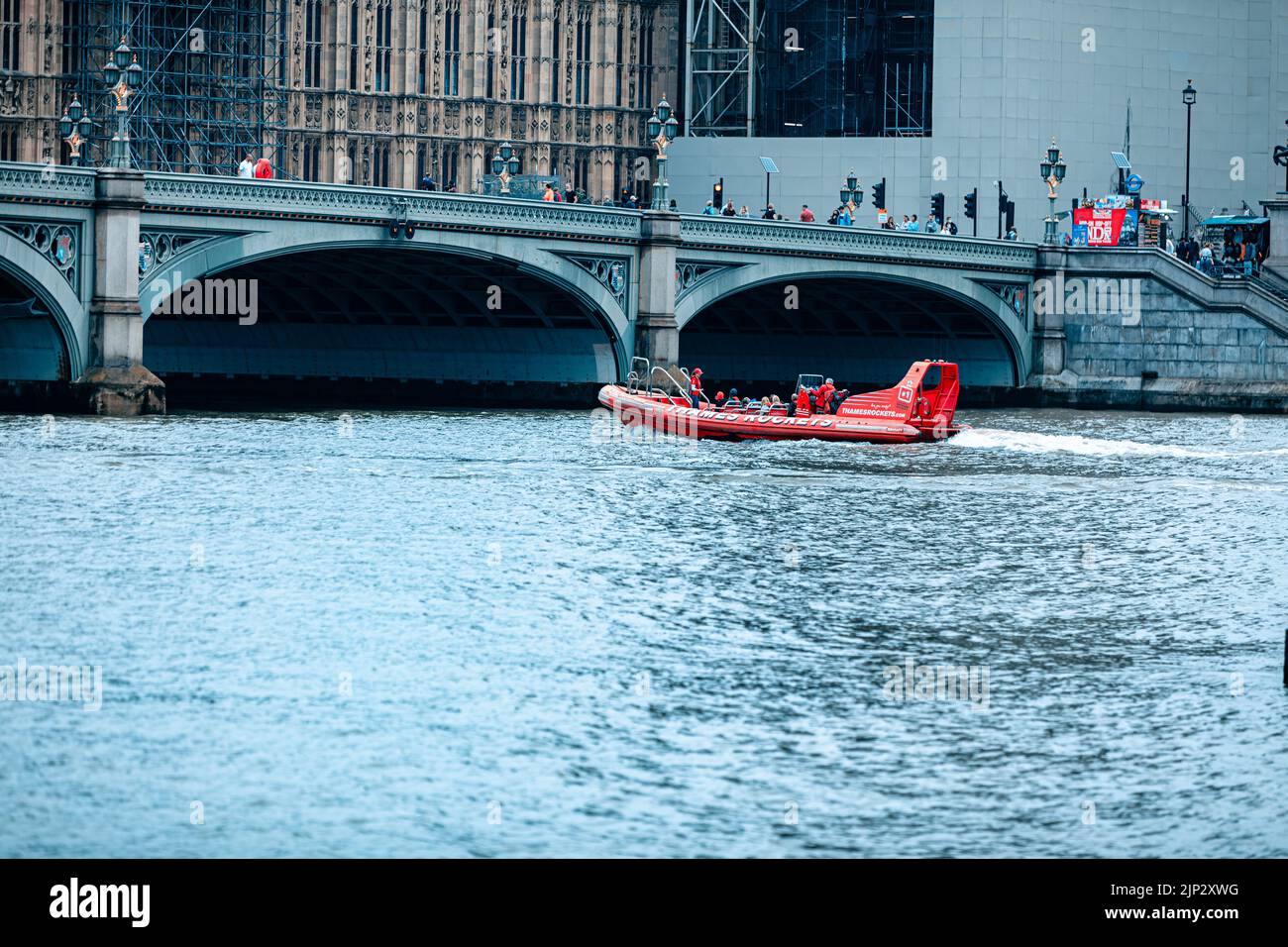The red boat on River Thames approaching Westminster Bridge. London ...
