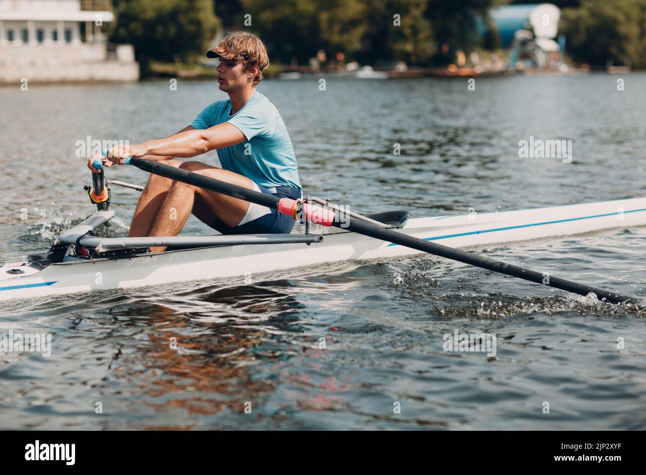 Sportsman single scull man rower rowing on boat Stock Photo - Alamy