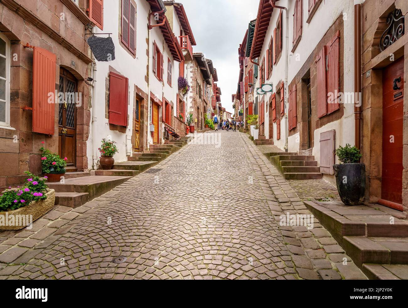 Street in perspective up the slope of town in the French Basque country ...