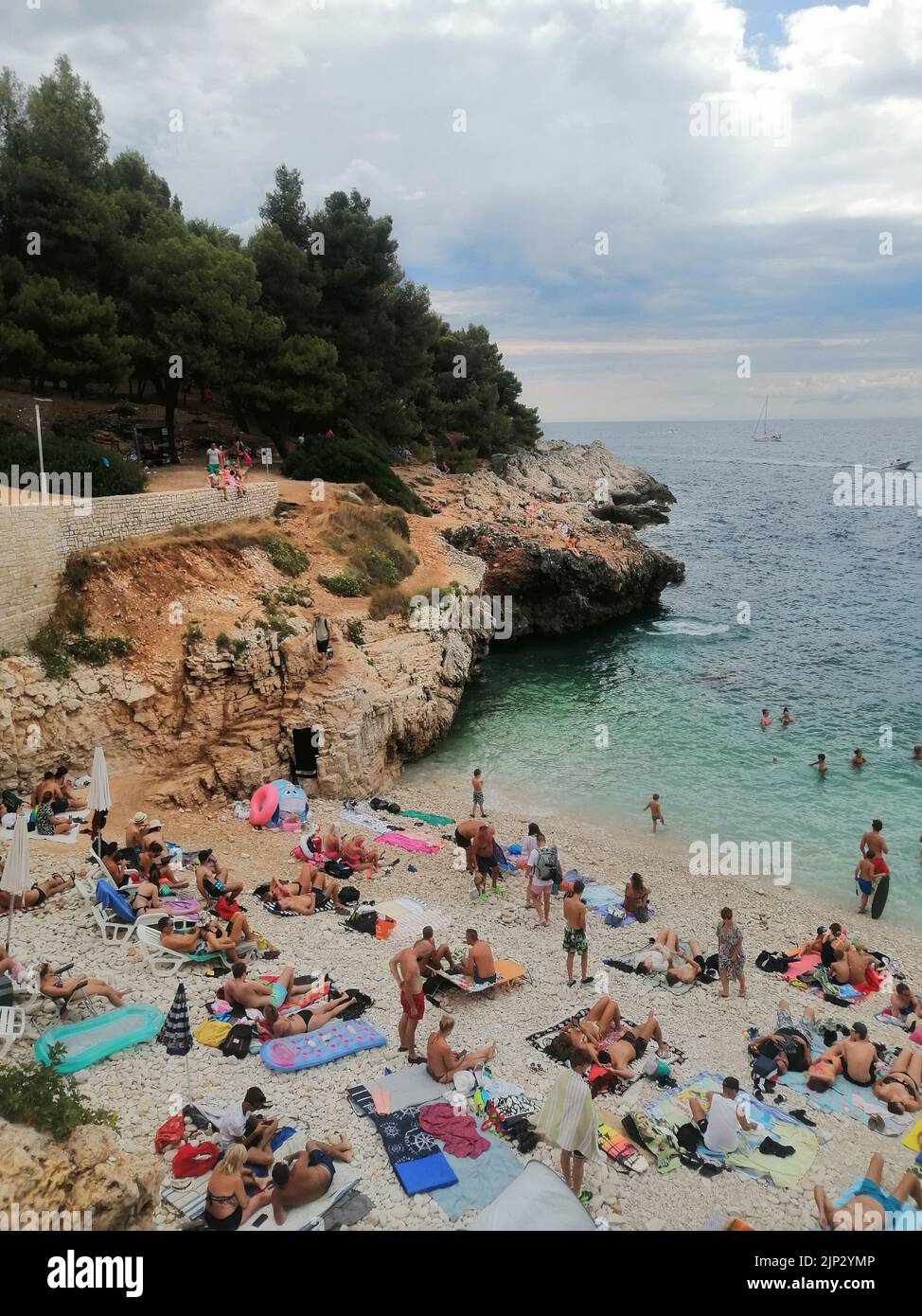 An aerial view of people resting and bathing by the Hawaii beach on a ...