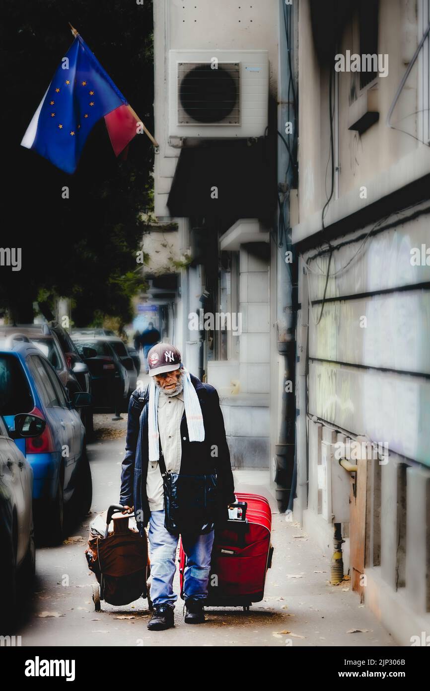 A homeless man walking with his possessions with the European Union ...