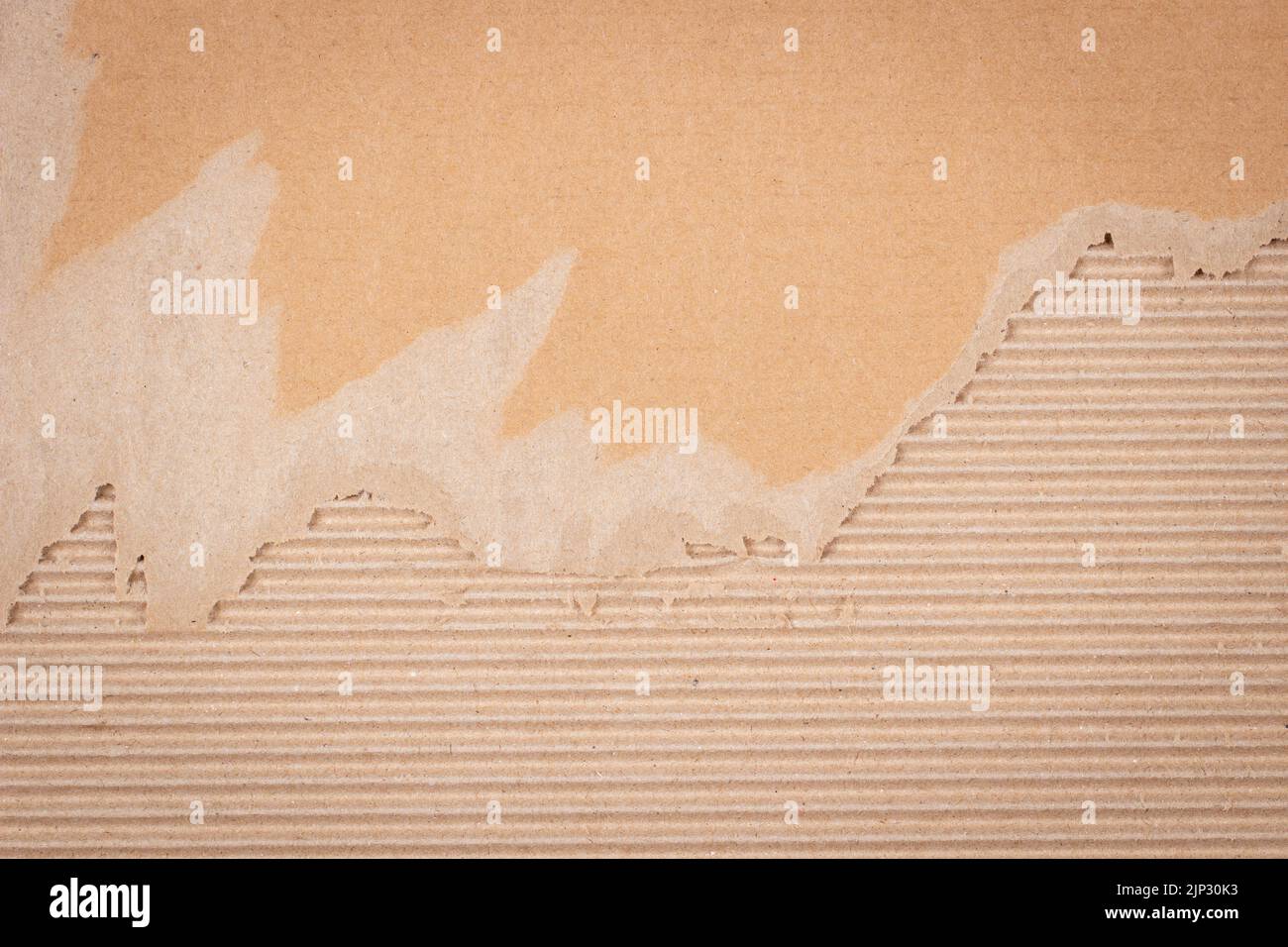Brown corrugated cardboard with torn edges. Cardboard packaging mesh ...
