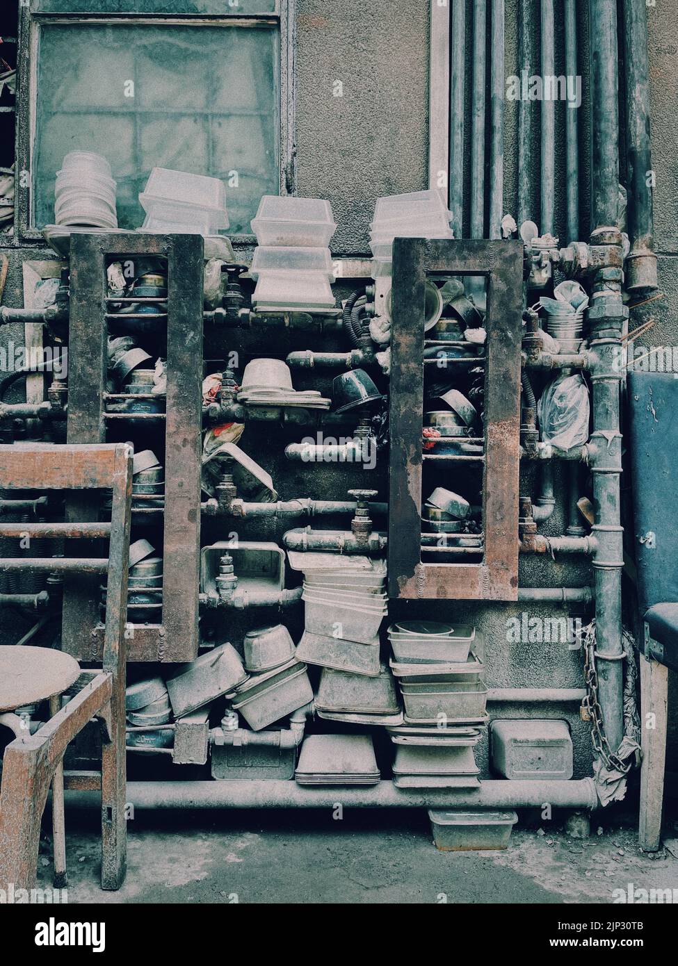 A vertical shot of old plastic containers on rusty shelves Stock Photo ...