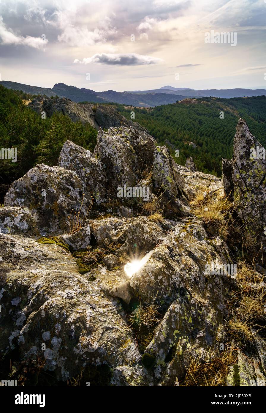 Landscape of rocks with green plants, dramatic sky with clouds and ...