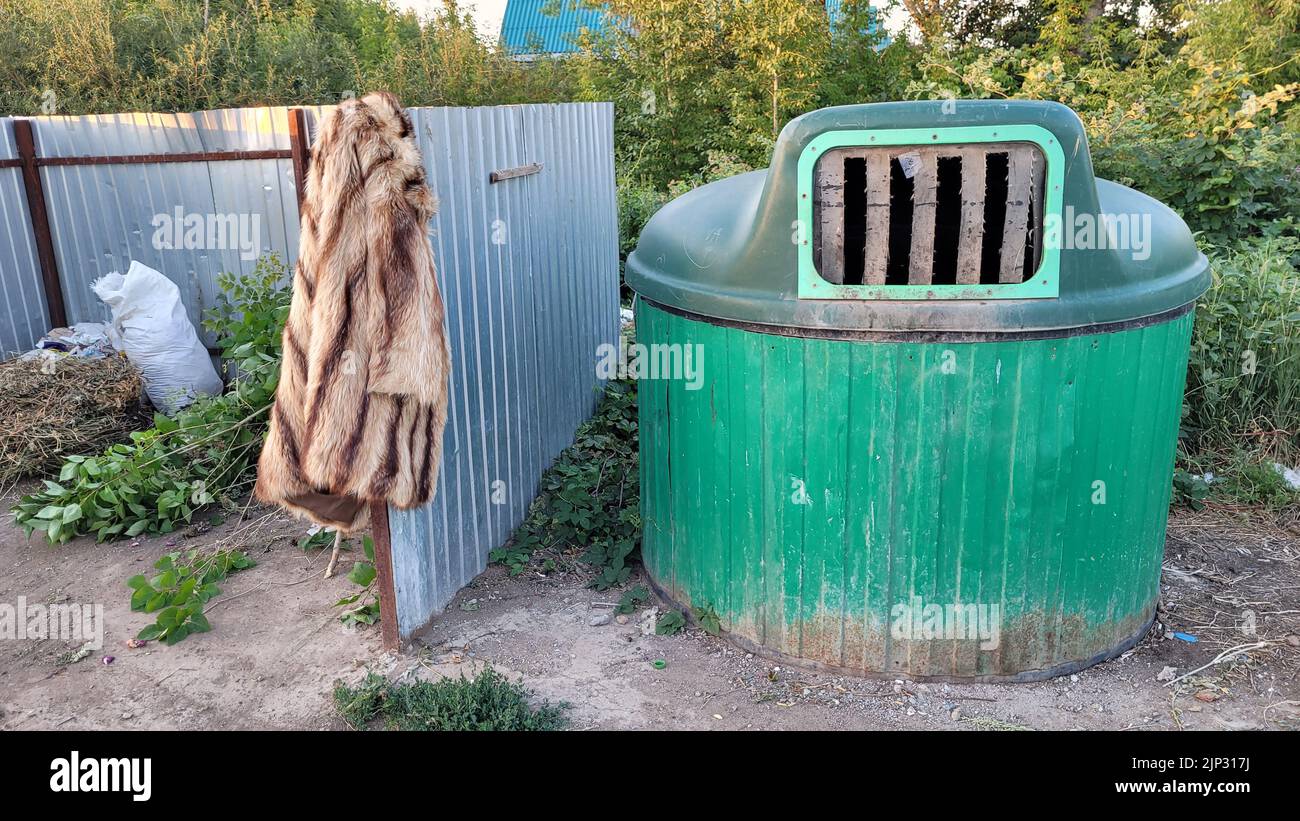 Women's natural fur coat thrown into the trash unnecessary Stock Photo ...