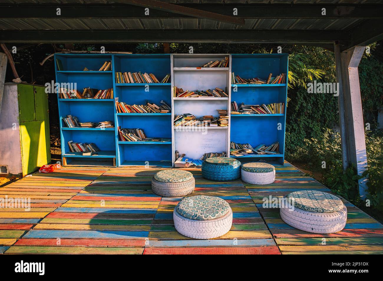 Beautiful bookstore with a reading corner full of books, colorful floor ...