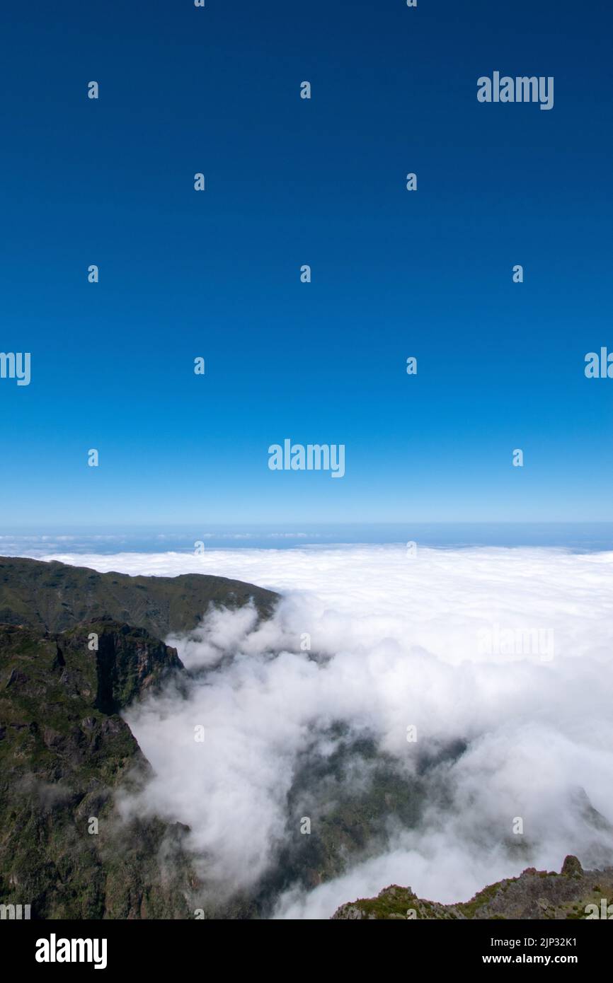 A vertical shot of picturesque Madeira from a mountain peak with dense ...