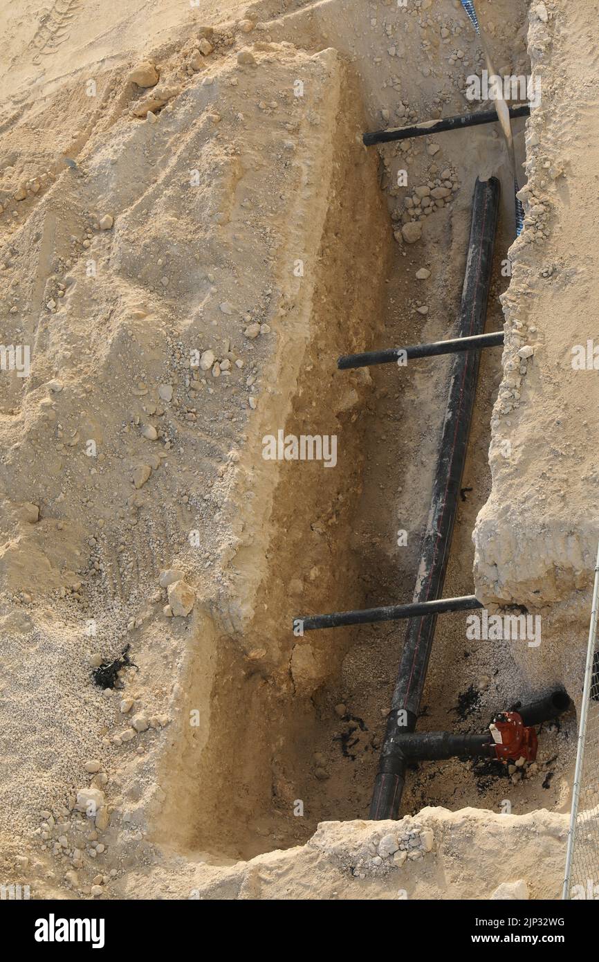 Construction work on the pipe laying of the pipeline into the trench ...