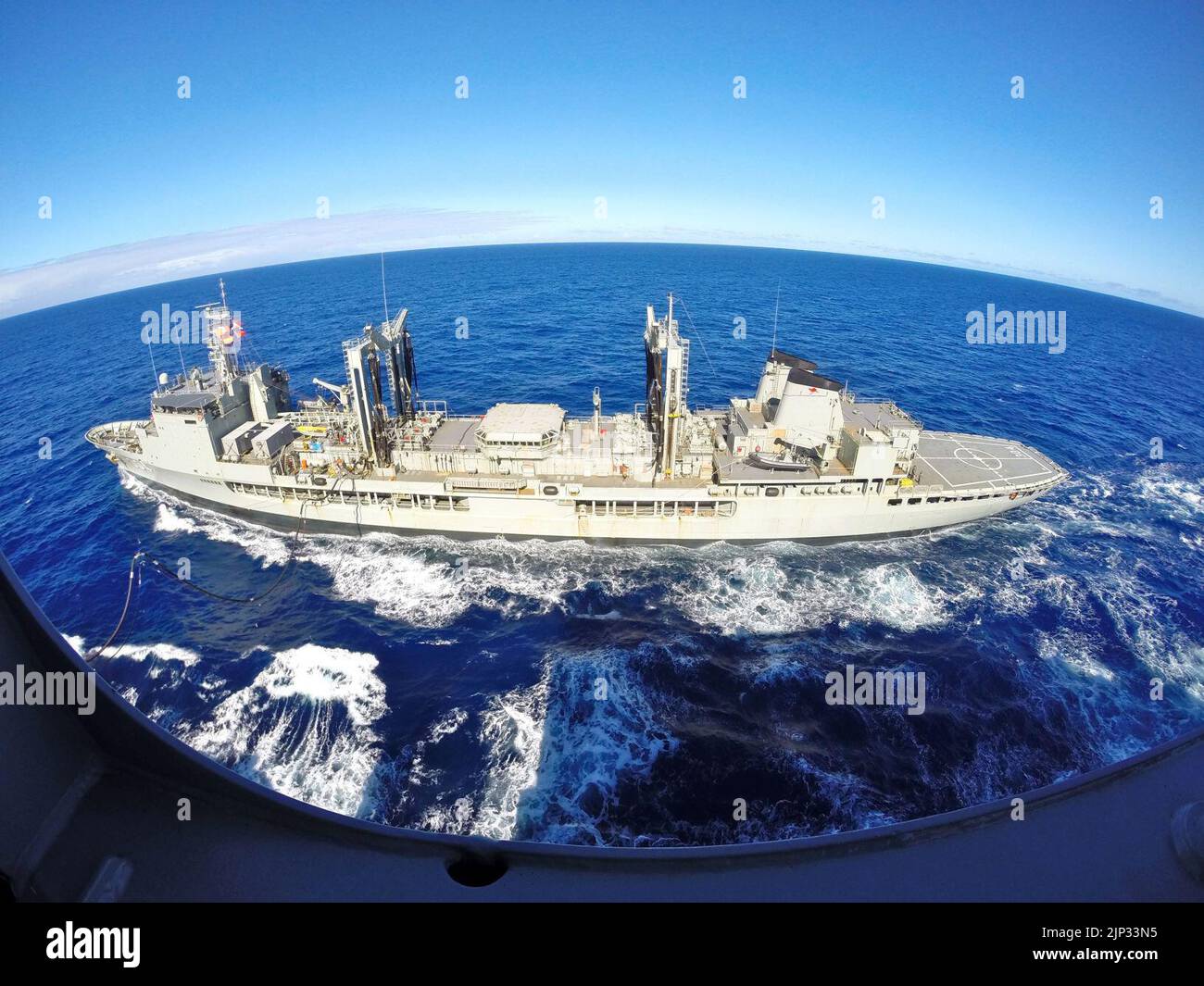 The dry cargo and ammunition ship USNS Cesar Chavez (T-AKE 14) conducts ...