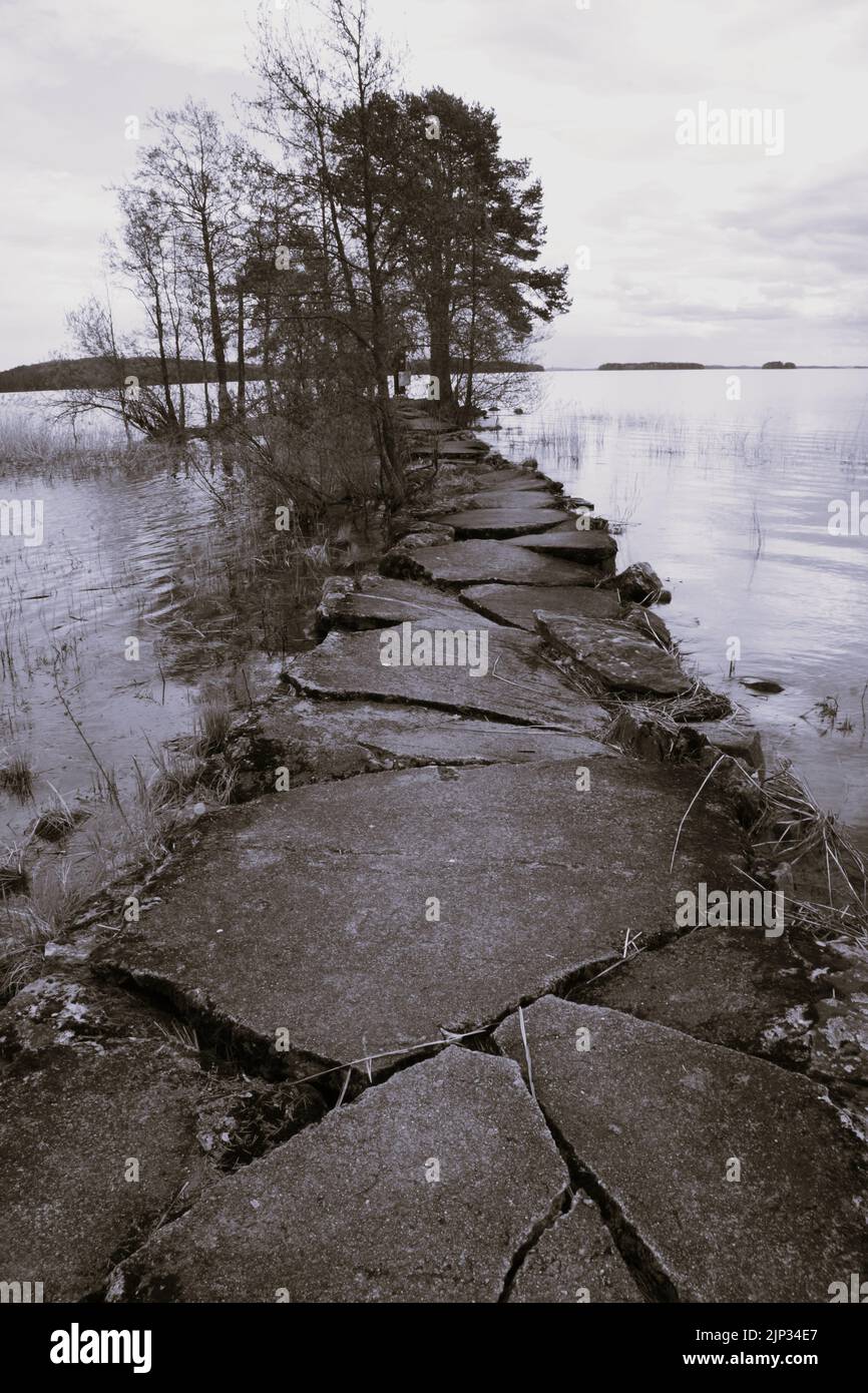 A vertical grayscale of a path through the water made of rock Stock ...
