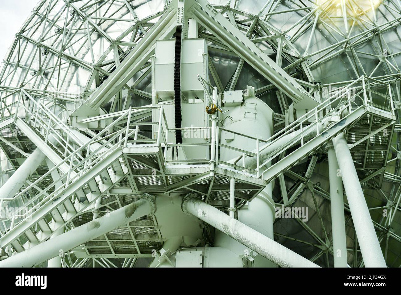 An exterior of a huge factory with metal tubes and stairs - industrial ...