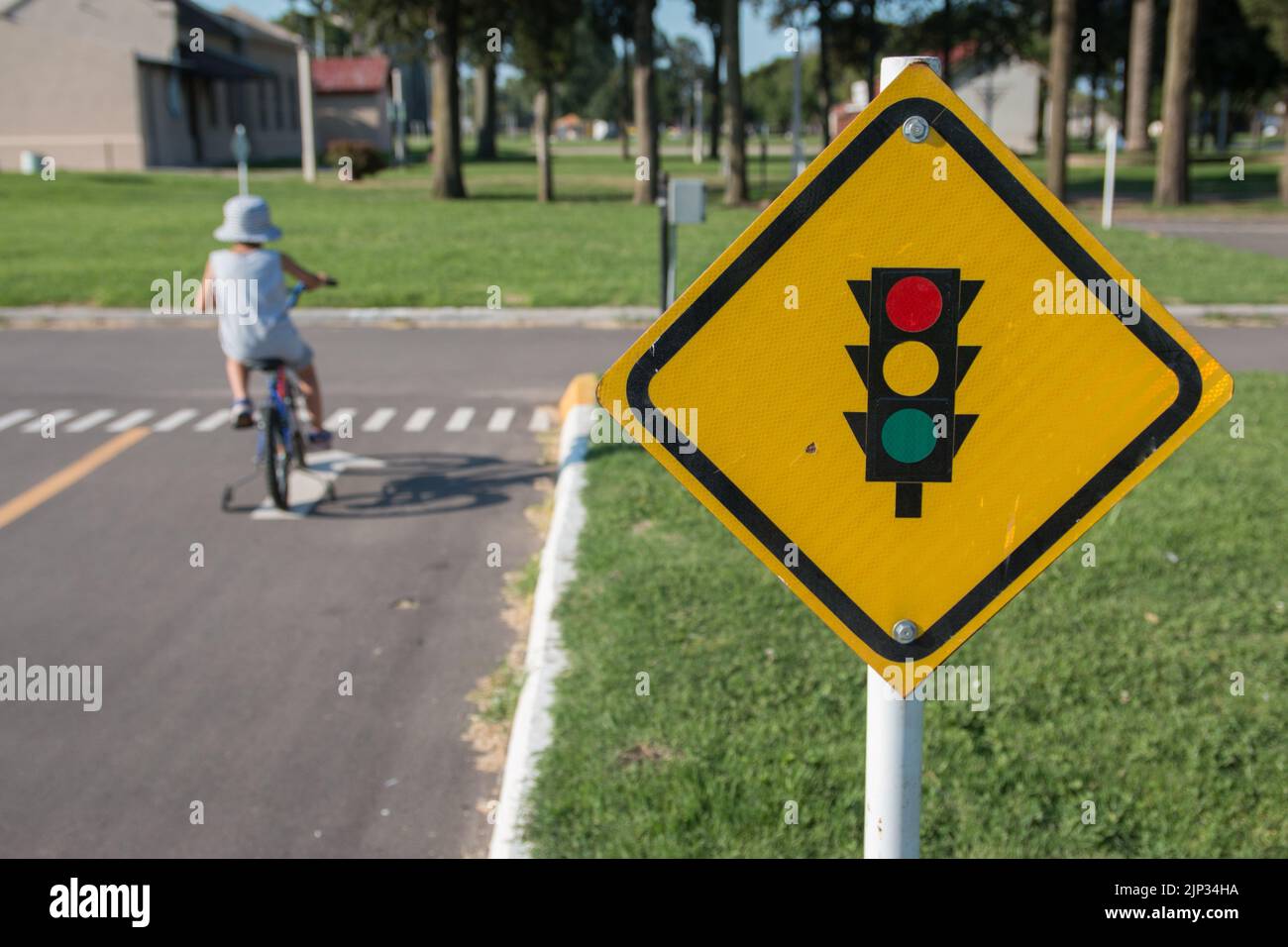 A yellow sign with traffic lights against a background of a child on a ...
