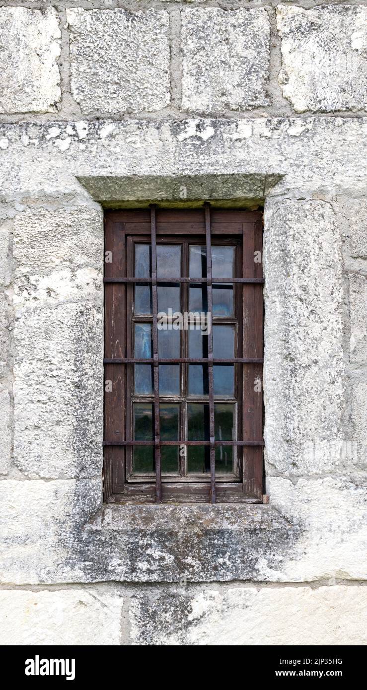 a window with bars on the old castle is shot close-up Stock Photo - Alamy