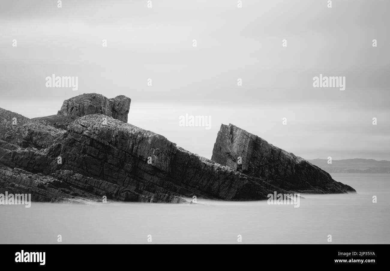 Long exposure of clouds and sea blurred around the famous rock outcrop ...