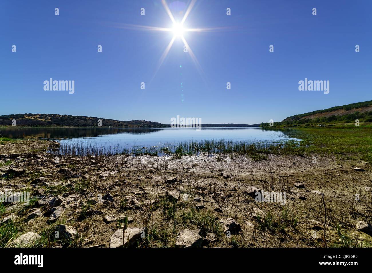 Desert landscape with a lake with little water and a drought ...