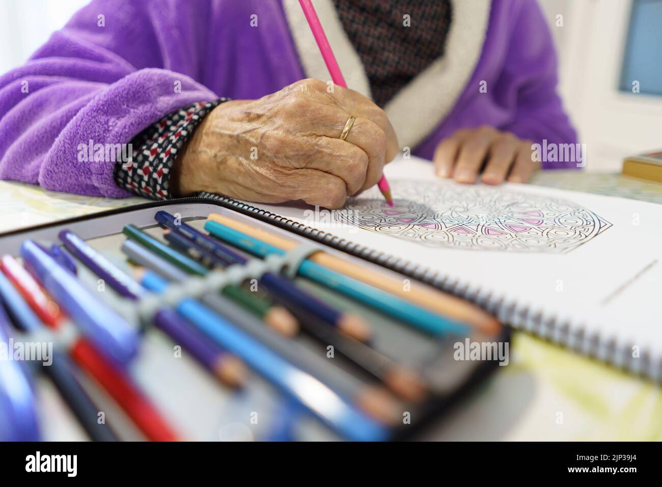 Elderly person drawing at home and doing homework in confinement due to ...
