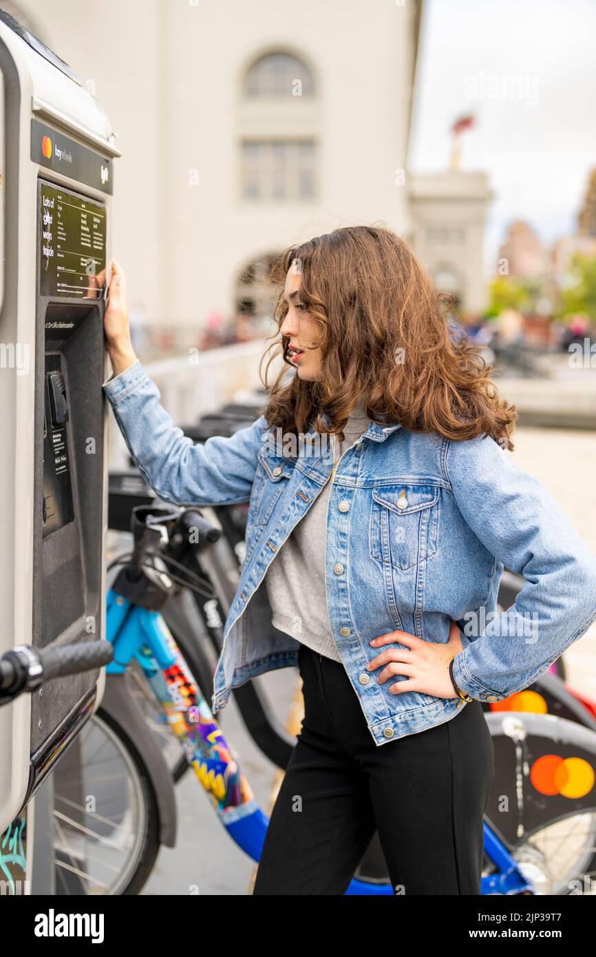 Young Woman Renting an ebike | Bicycle Rental | Transportation | Bike ...