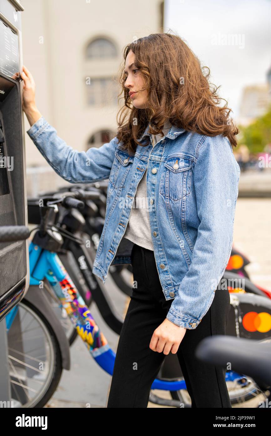 Young Woman Renting an ebike | Bicycle Rental | Transportation | Bike ...