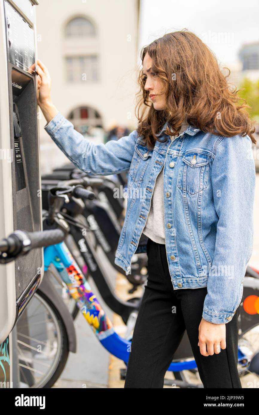 Young Woman Renting an ebike | Bicycle Rental | Transportation | Bike ...