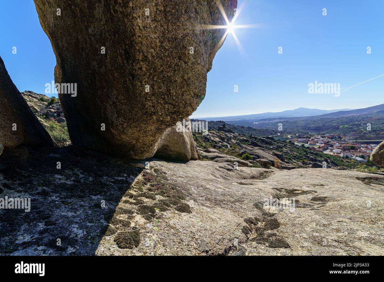 Mountain landscape with large granite rocks, blue sky and sun on the ...